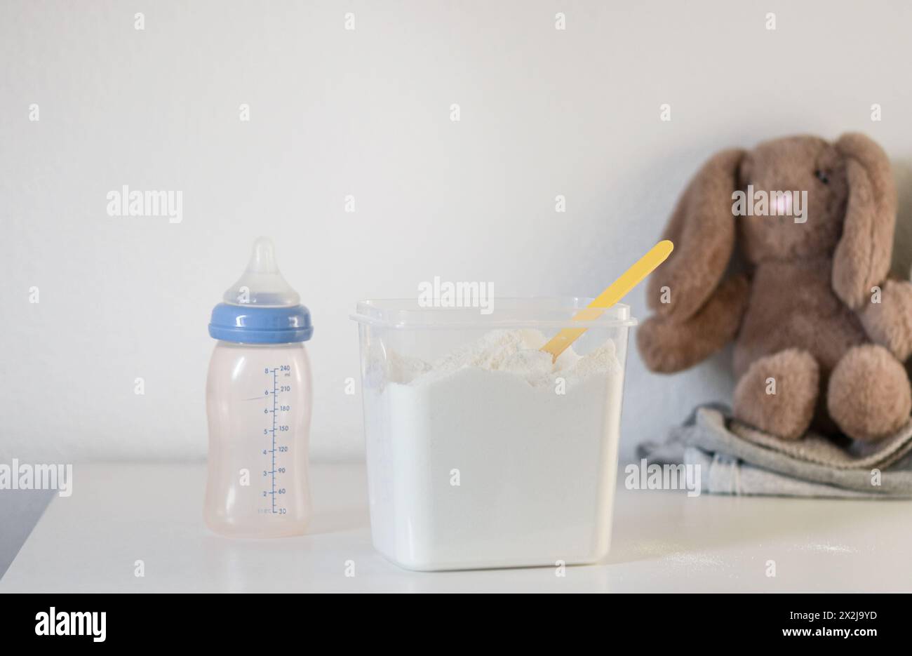 Dry powder formula milk for feeding babies in a can with yellow plastic ...