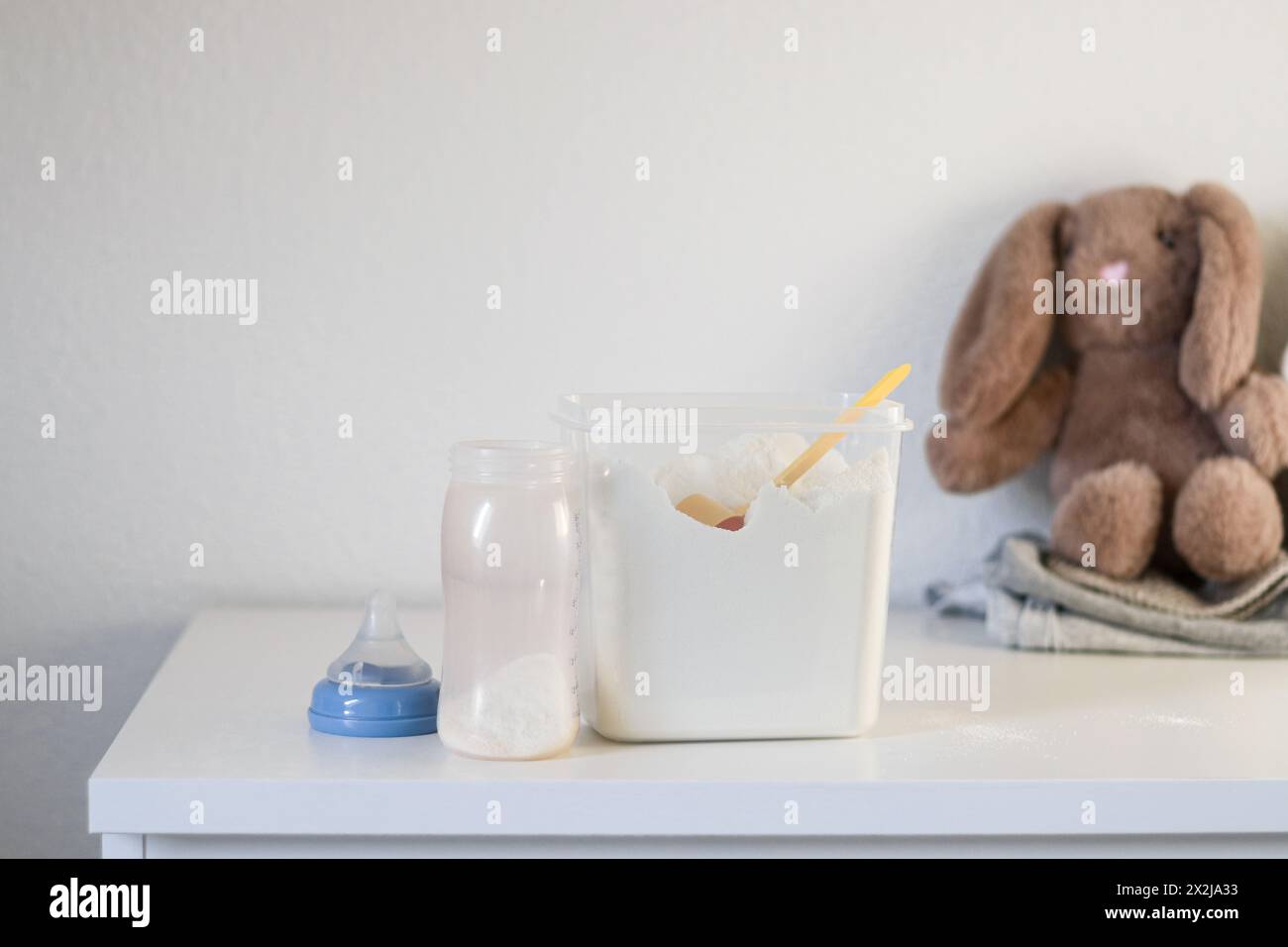 Dry powder formula milk for feeding babies in a can with yellow plastic ...