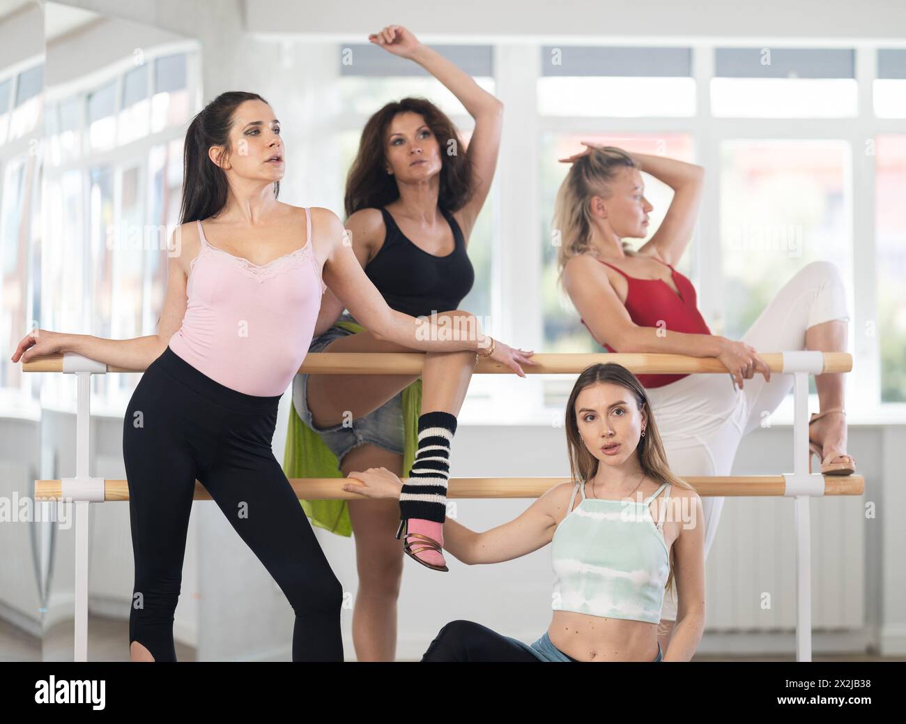 Group of women in high heels posing at barre Stock Photo - Alamy