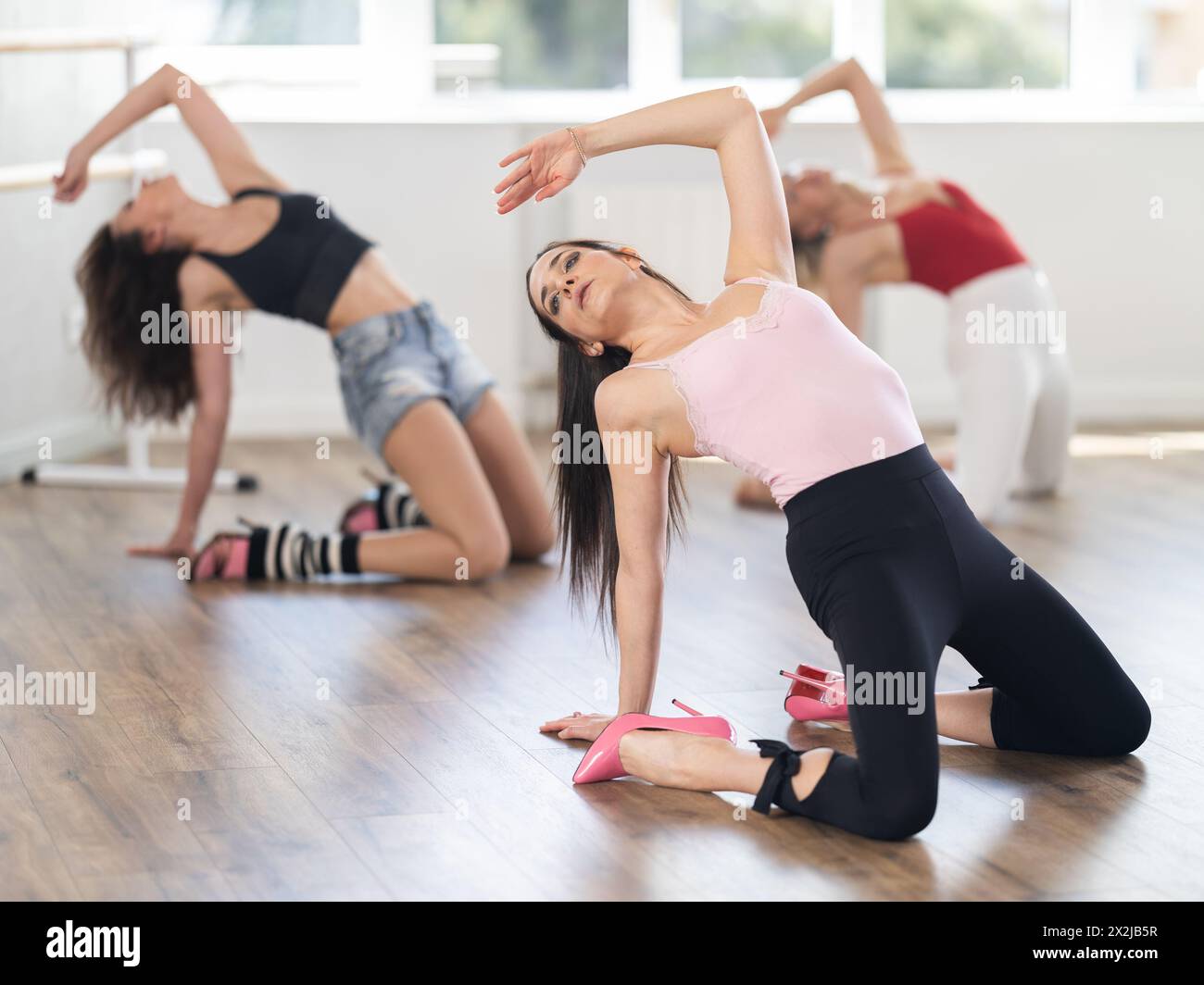 Group of women in high heels dances on floor Stock Photo - Alamy