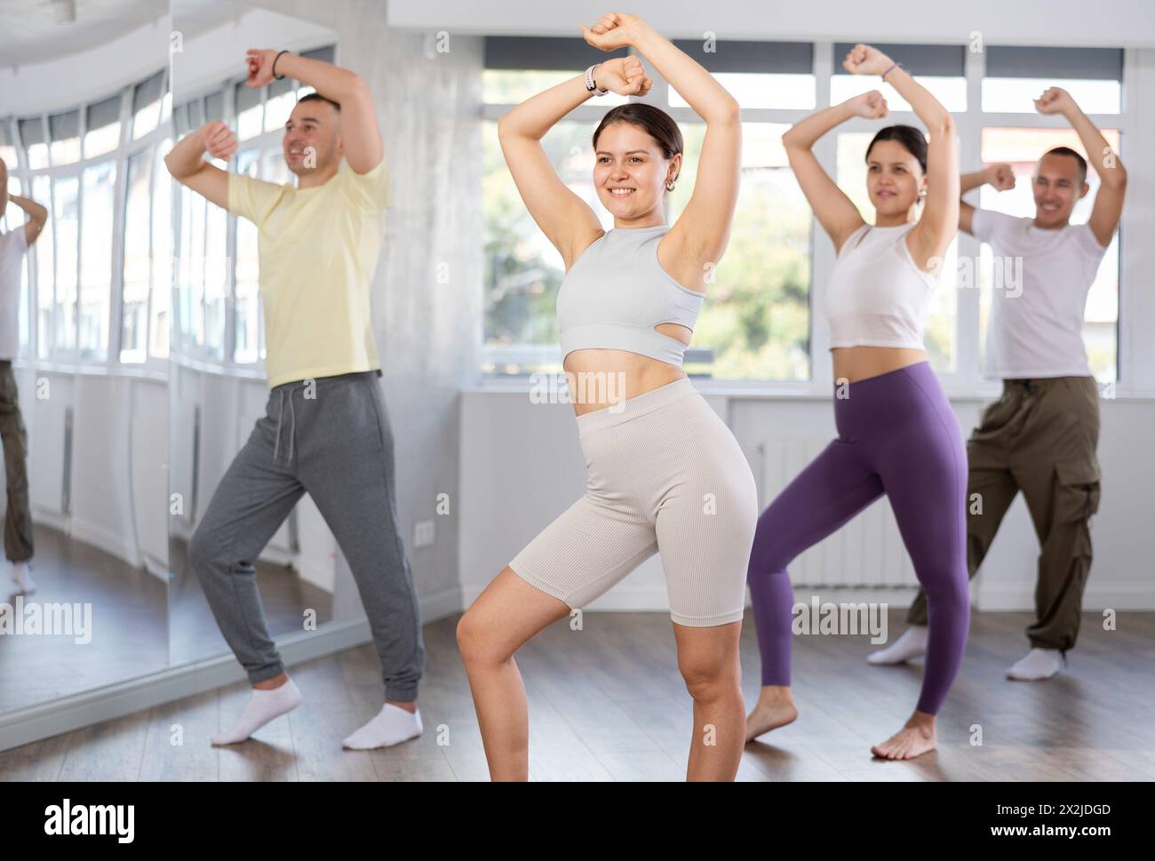 Young fit girl energizing group during dance fitness class Stock Photo ...