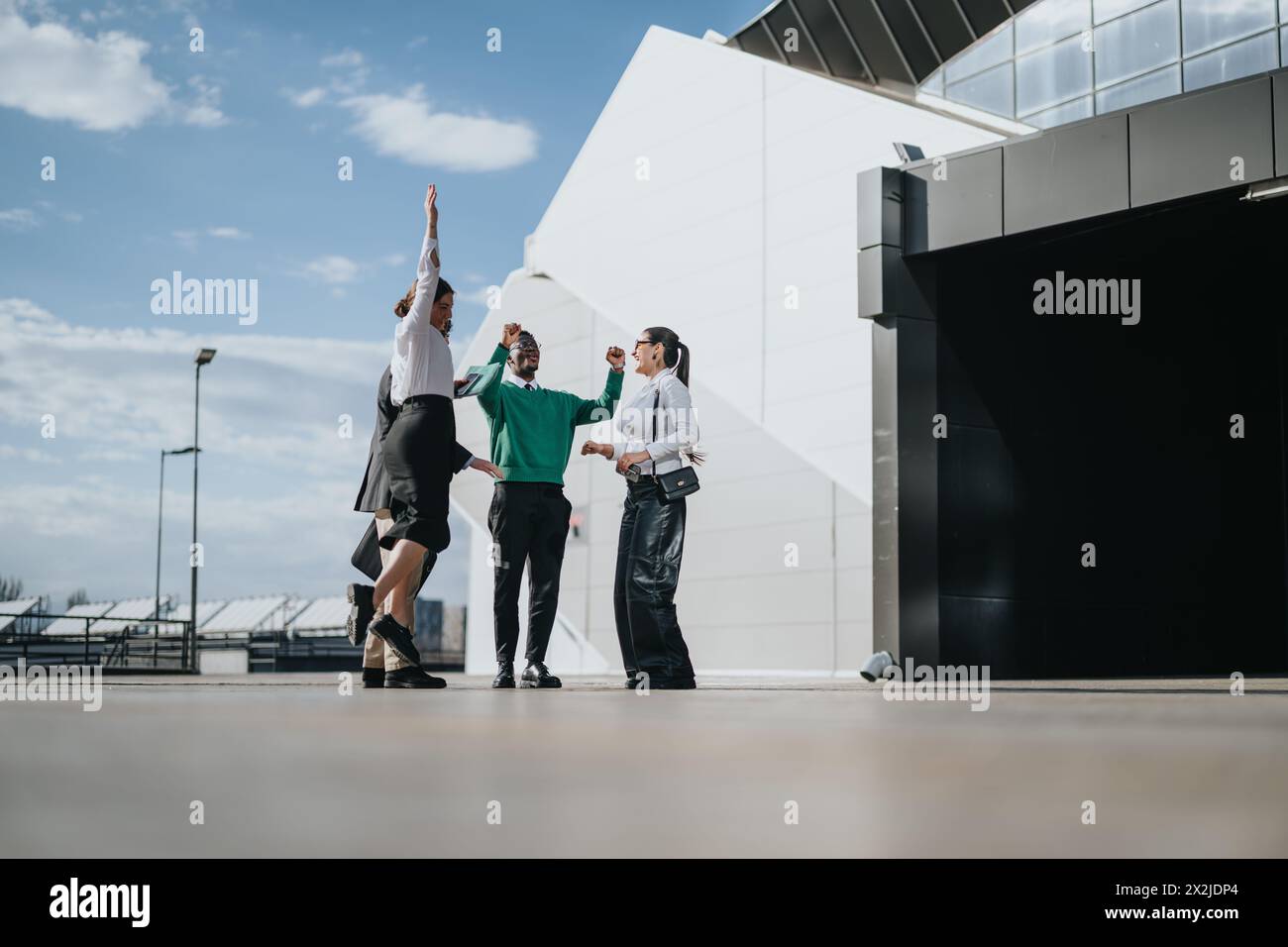 Enthusiastic team celebrating success outside the office building Stock ...
