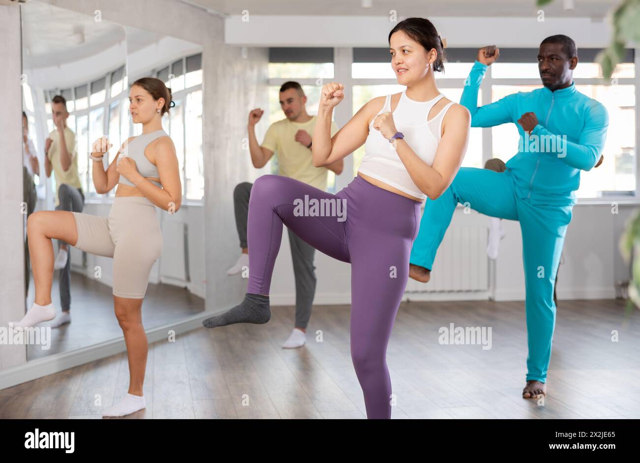 Asian girl practices kicking and punching in process of self-defense at ...