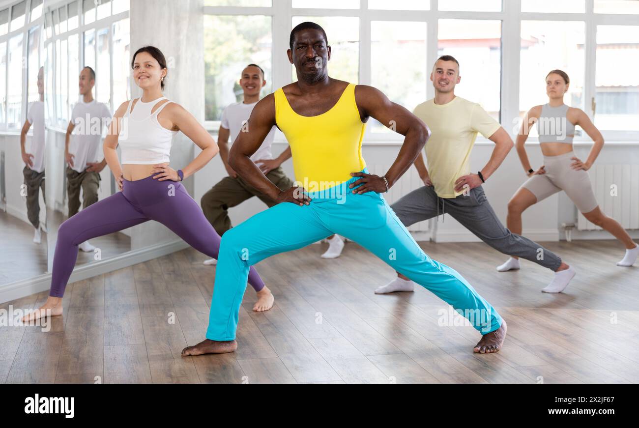 Group of people warming up before dance class Stock Photo - Alamy