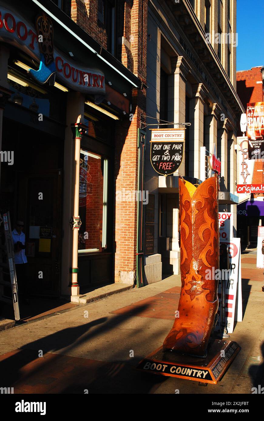 Two large boots stand outside a cowboy and western footwear store and ...