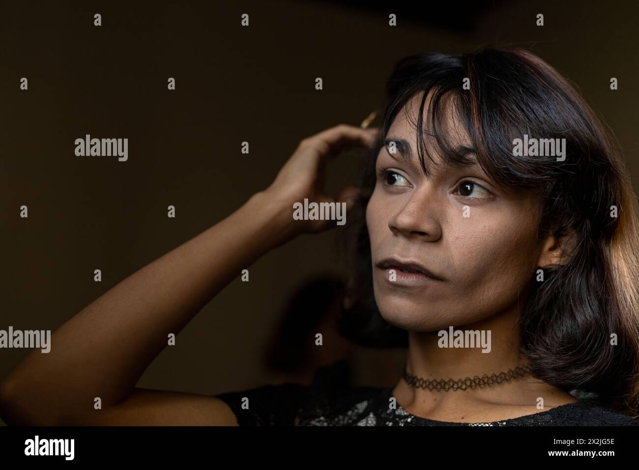 Young transgender man (26) is in his room applying makeup. Transgender ...