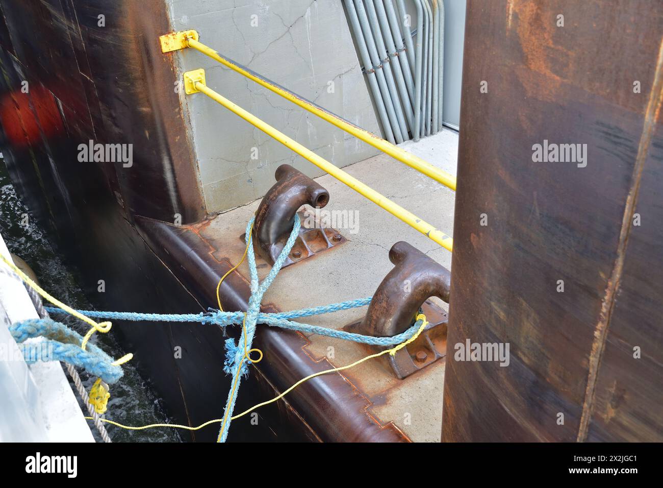 Mooring Bollards with large diameter blue ropes to hold a ferry at dock ...