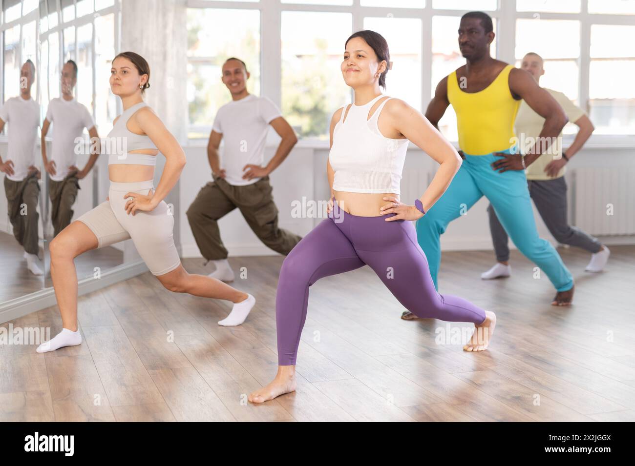 Group of people warming up before dance class Stock Photo - Alamy