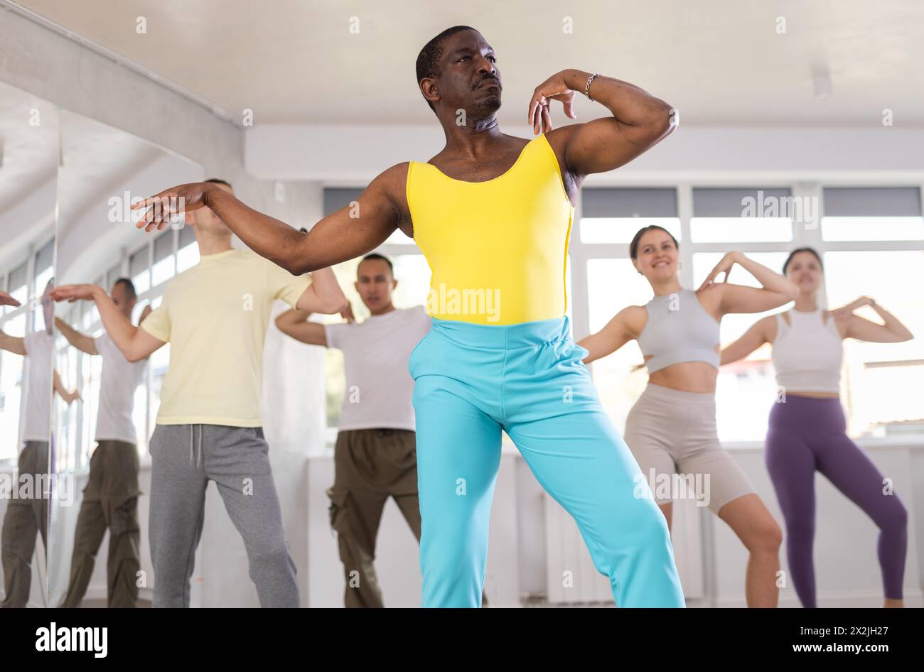 Middle-aged african-American man practicing jazz-funk dance in training ...