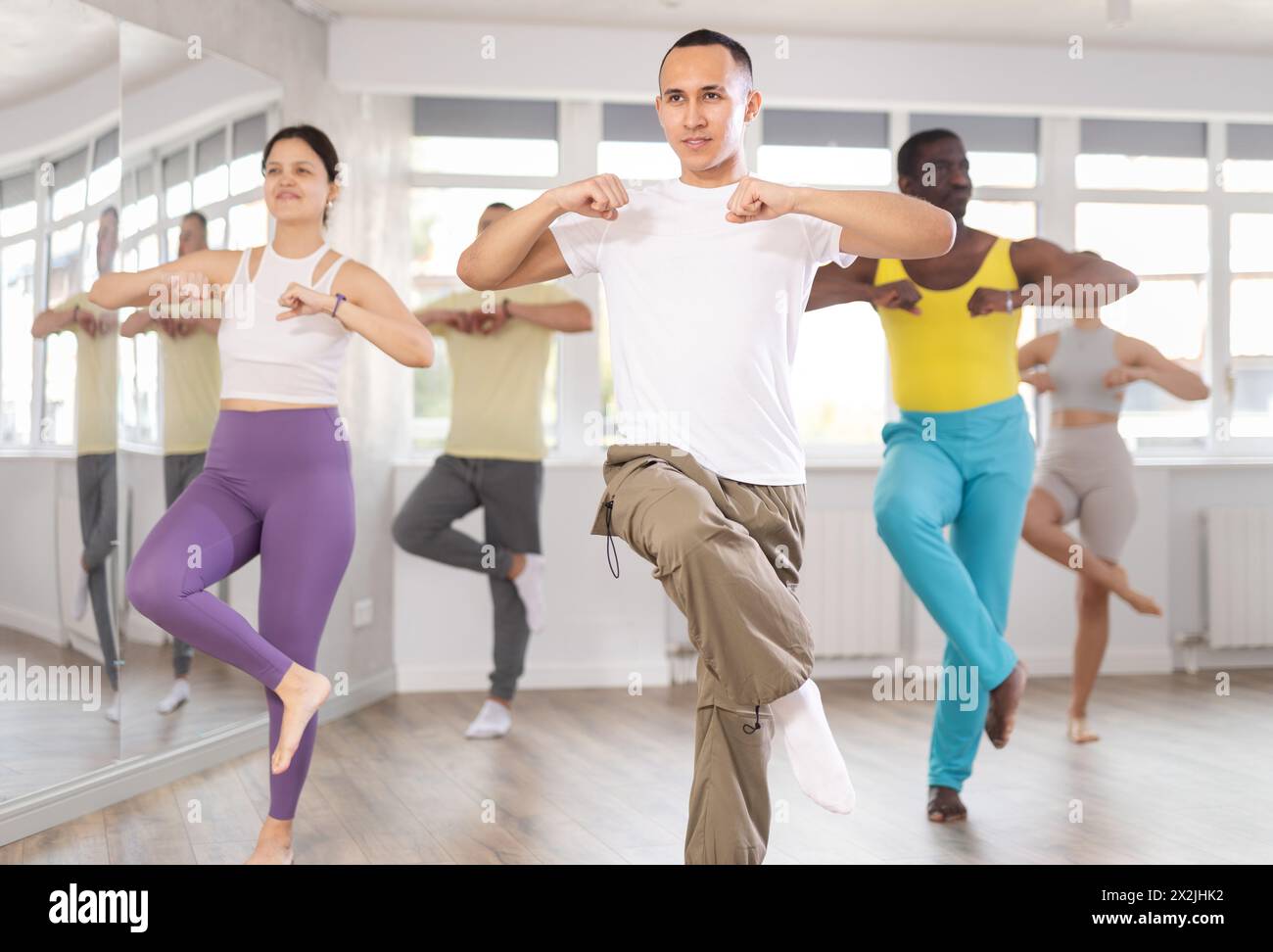 Group of multiethnic active people dancing and learning movements of ...