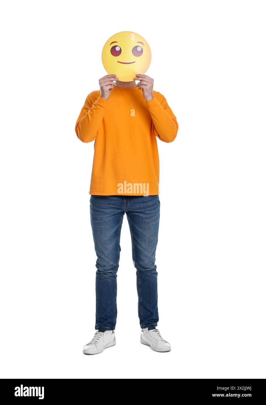 Man covering face with smiling emoticon on white background Stock Photo ...