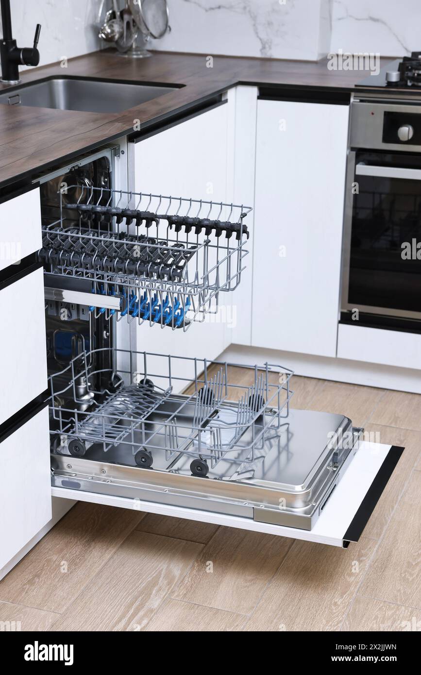 Open clean empty dishwasher in kitchen. Home appliance Stock Photo - Alamy