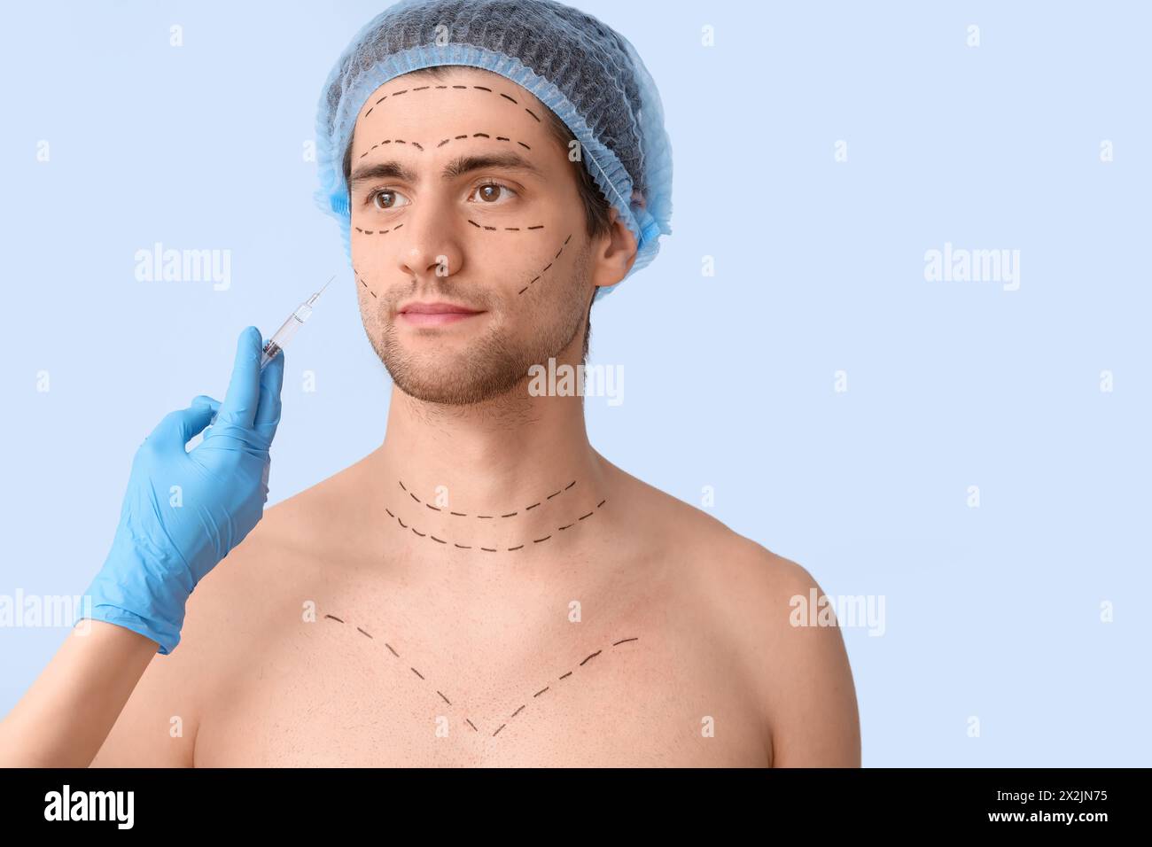 Young man with marked face receiving injection on blue background ...