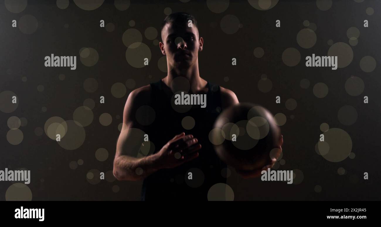 Image of caucasian basketball player throwing ball and spots of light ...