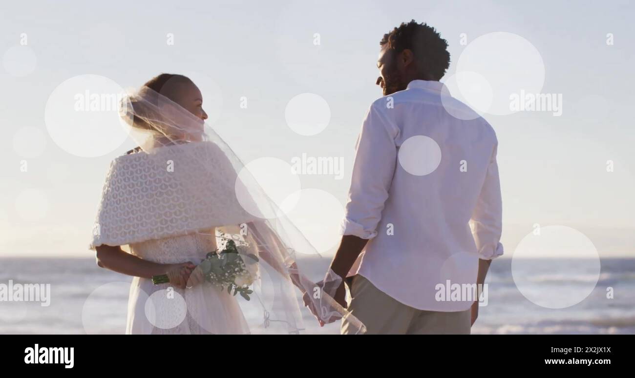 Image of light spots over african american couple getting married on ...