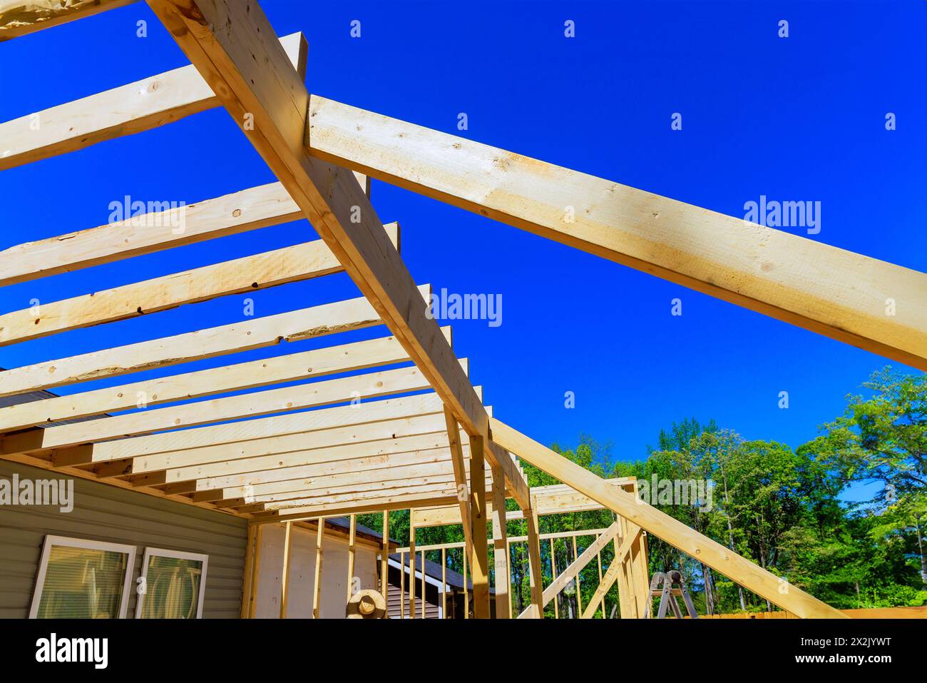 An unfinished interior of newly built house with wooden framing ...
