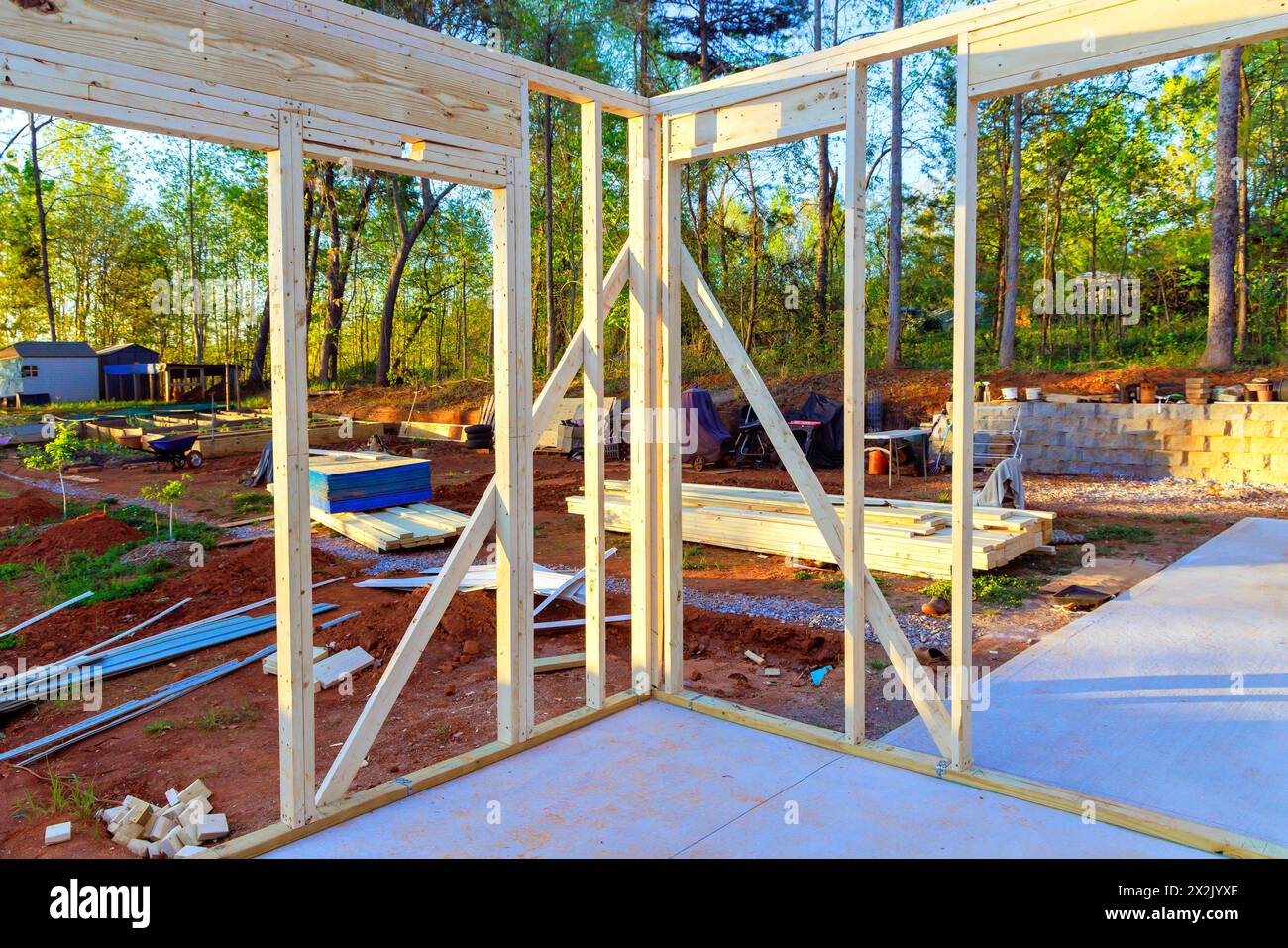 An unfinished interior new house with wooden framing supporting beams ...