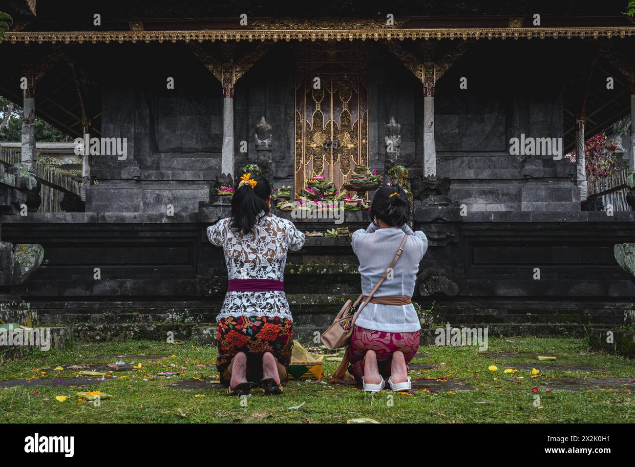 This striking image captures two women dressed in traditional Balinese ...