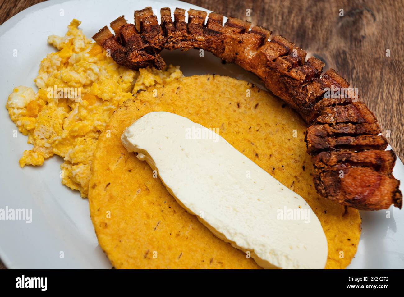 Traditional Colombian breakfast - Arepa, chicharron, cheese and fried ...