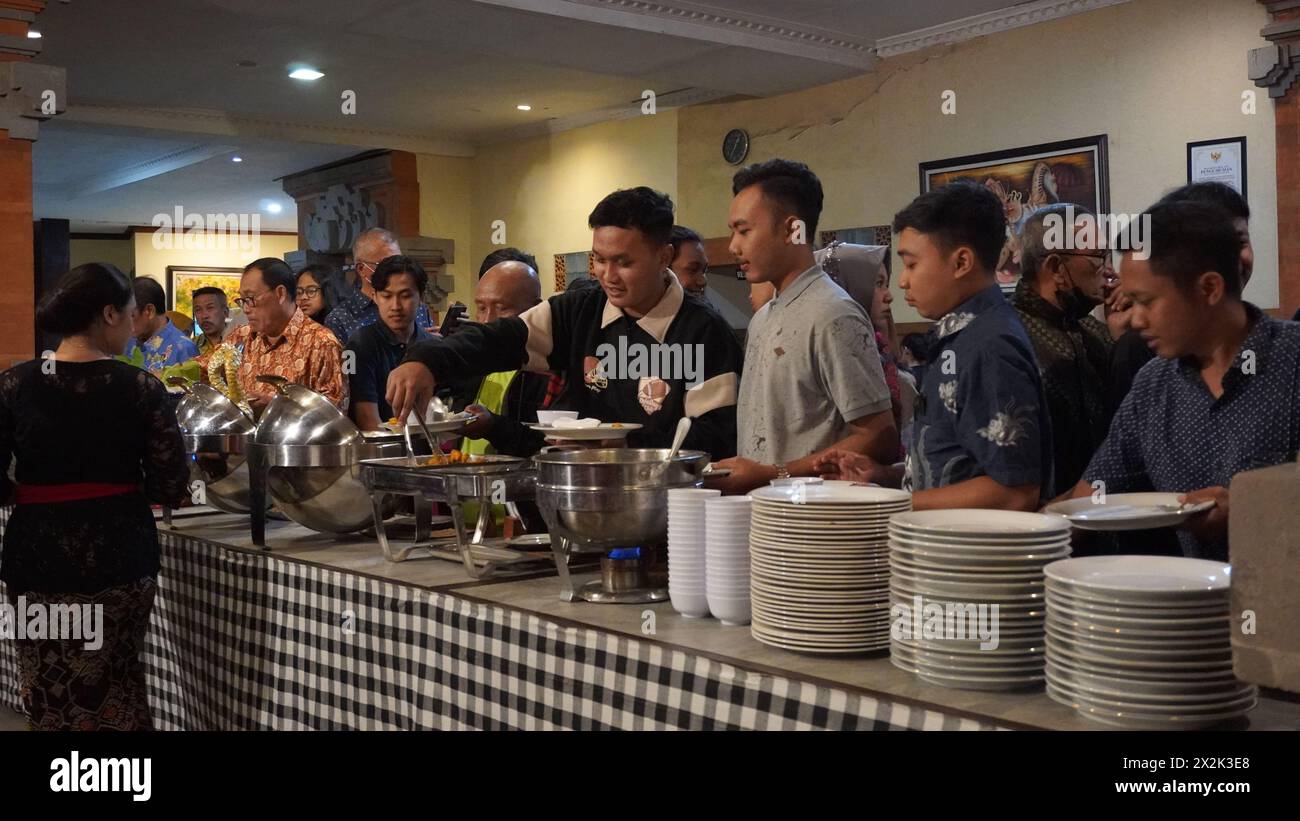 People take food in hotel buffet on the night of Halal Bihalal event ...