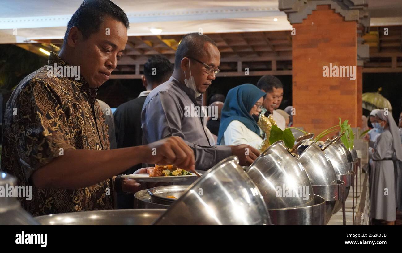 People take food in hotel buffet on the night of Halal Bihalal event ...