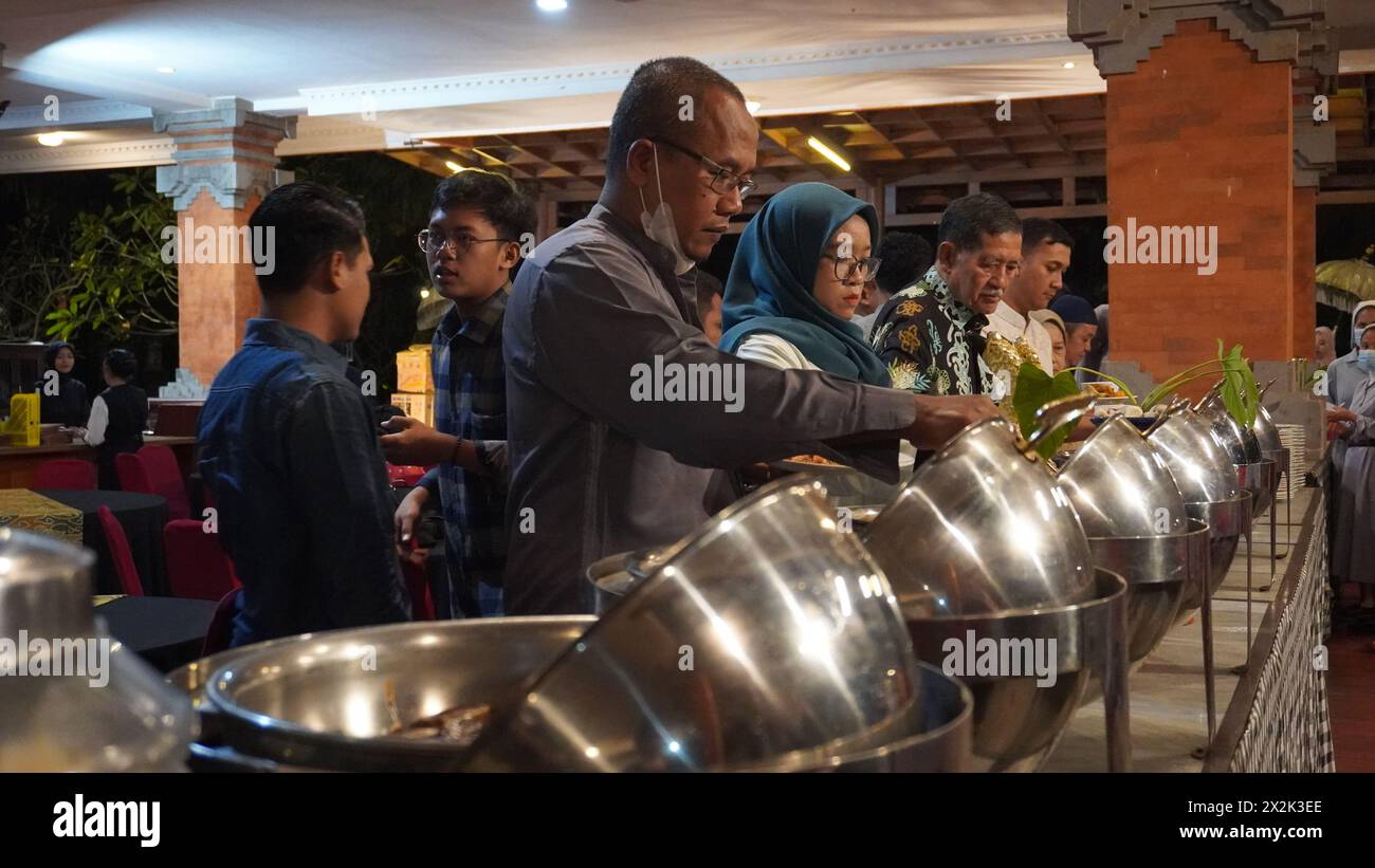 People take food in hotel buffet on the night of Halal Bihalal event ...