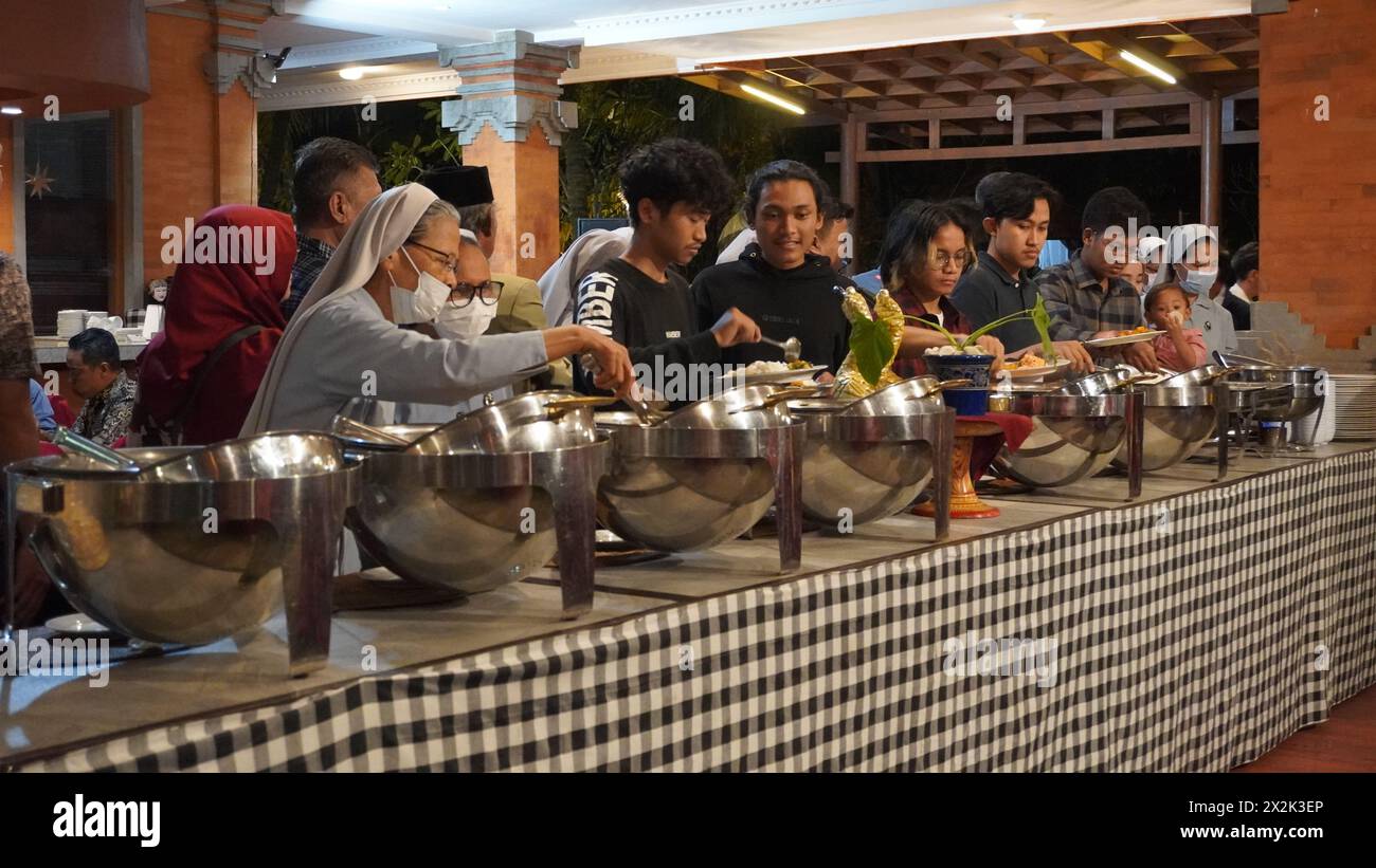 People take food in hotel buffet on the night of Halal Bihalal event ...