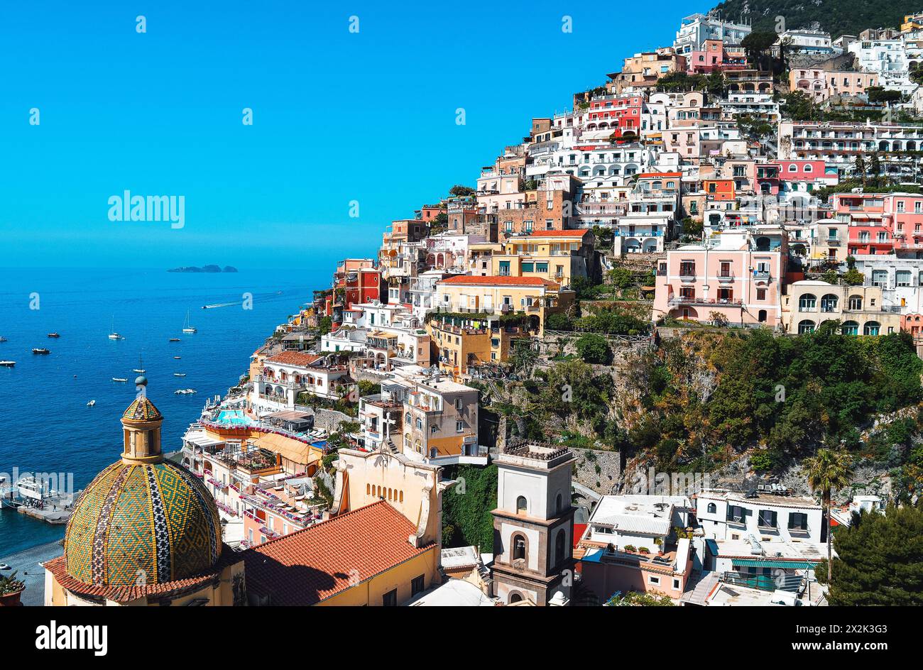 A vibrant view of Positano's terraced architecture against a sparkling ...