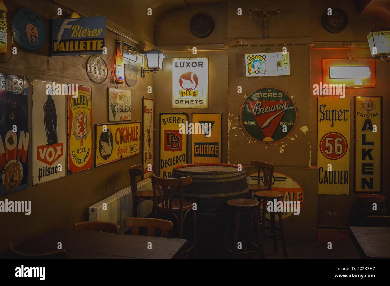 A cozy pub setting featuring vintage beer signs on a warm, dimly lit ...