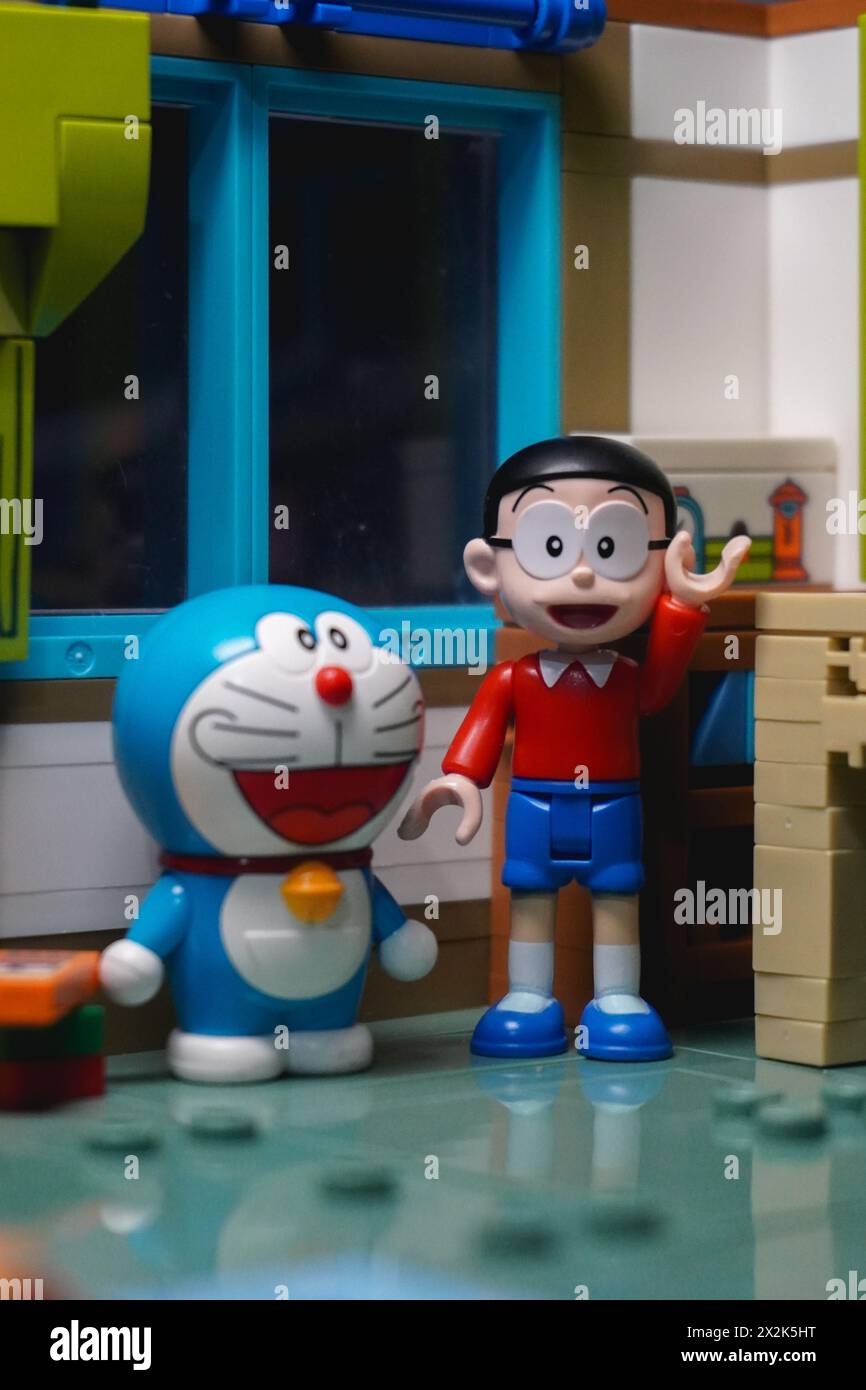The figure of Nobita is raising one of his hands and standing with ...