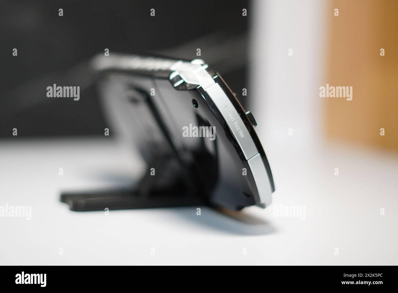 The back of a handheld game console from Sony called PSP is black on a ...