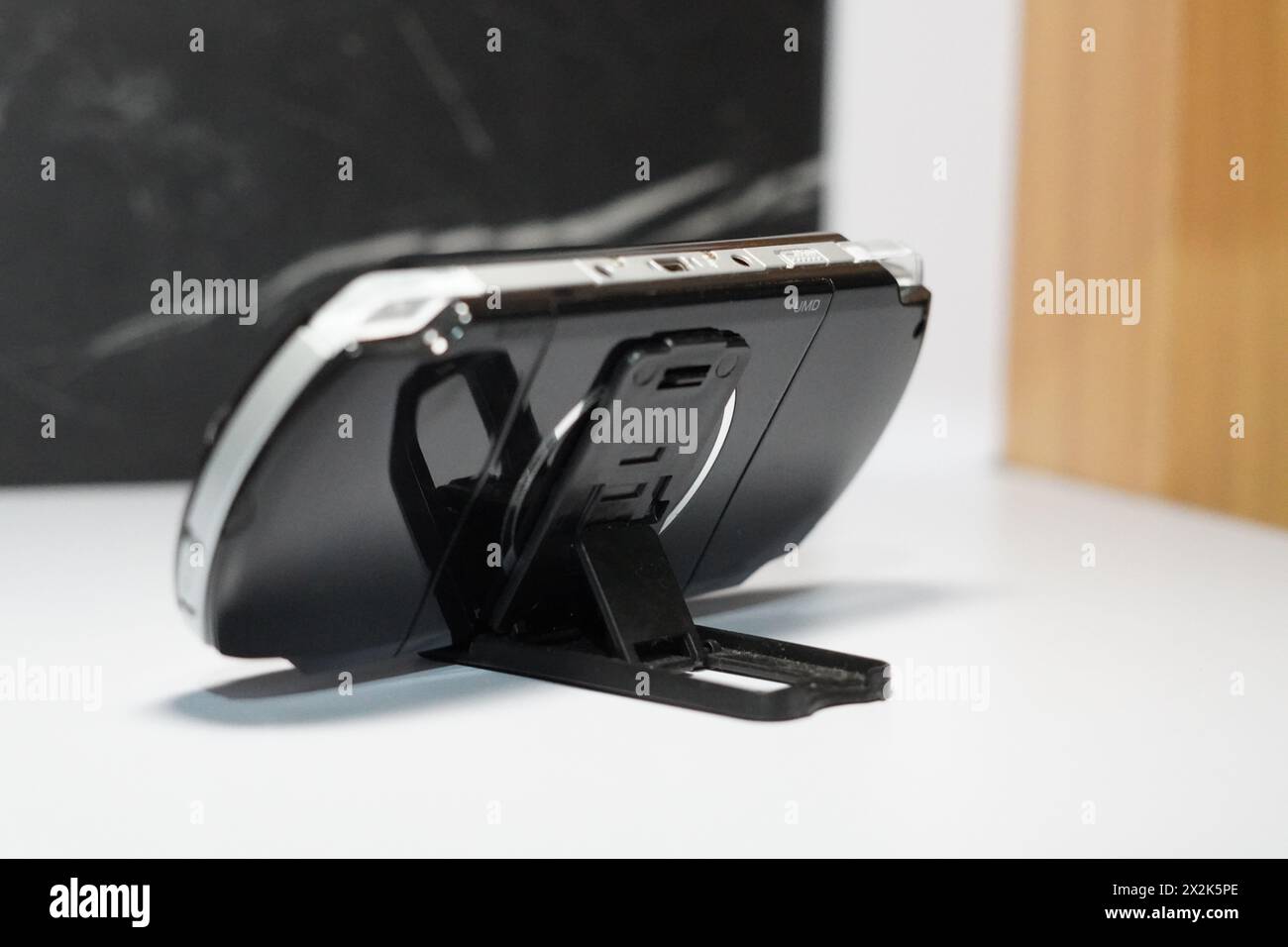 The back of a handheld game console from Sony called PSP is black on a ...