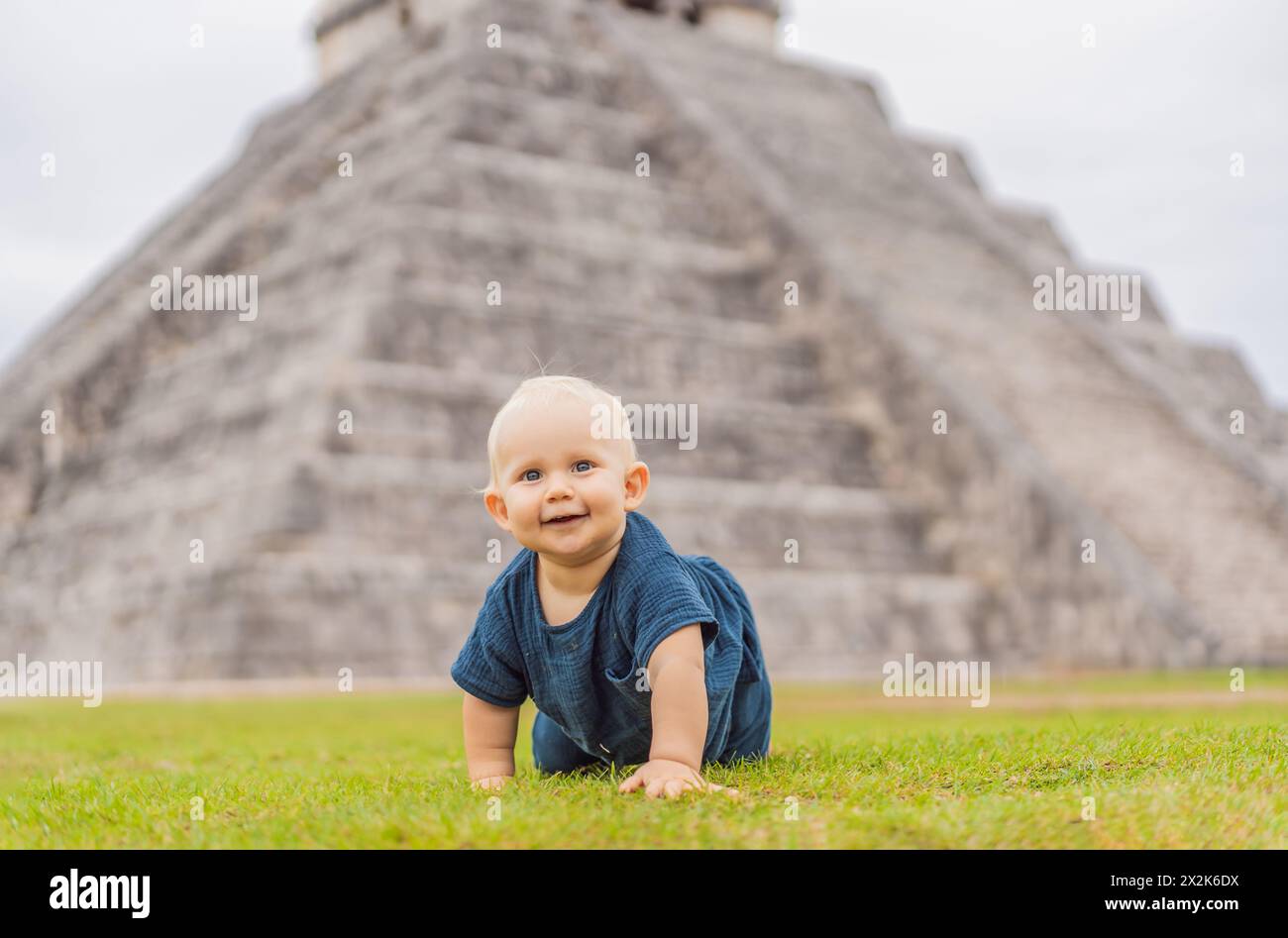 Baby traveler, tourists observing the old pyramid and temple of the ...