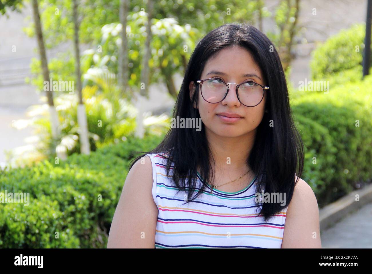 Teenage woman shows an attitude of annoyance and anger with a very irritable mood due to ...