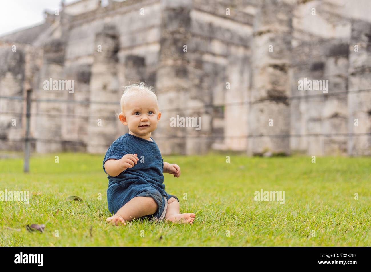 Baby traveler, tourists observing the old pyramid and temple of the ...
