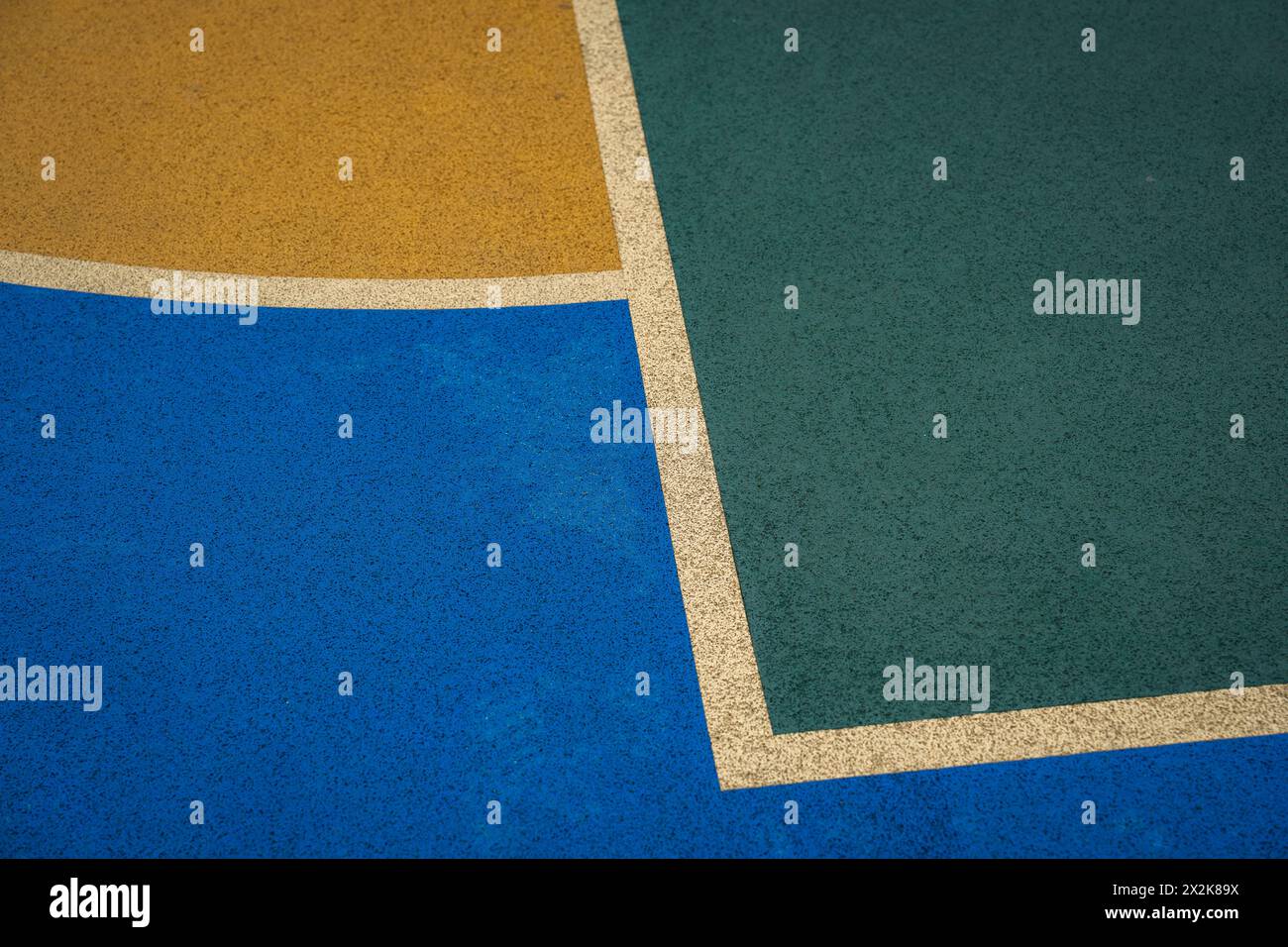 Close-up of a vibrant sports court surface with different colored areas ...