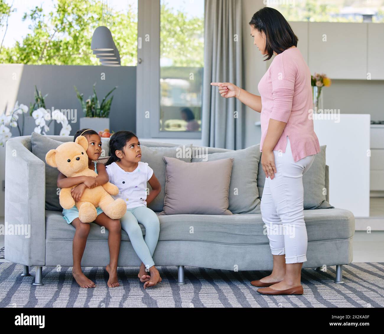 Mother, pointing and scolding child in home, discipline and ...