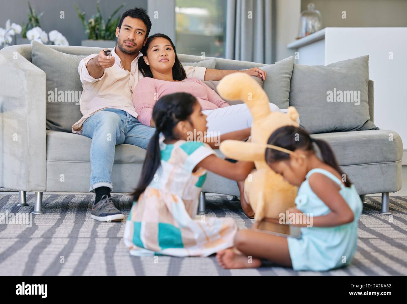 Relax, parents and kids on couch with busy family, watching tv and ...