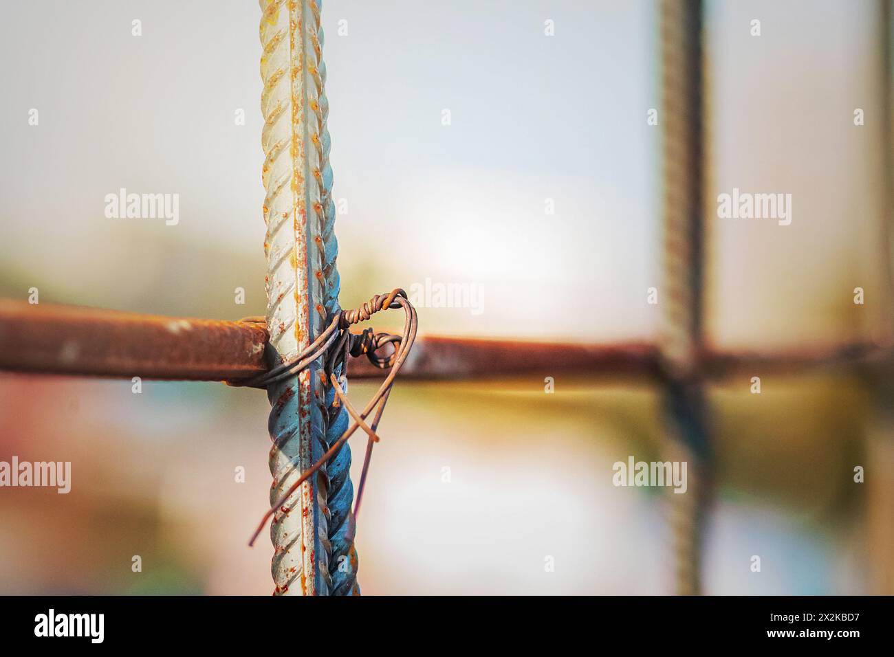 Fastening steel reinforcement with tying wire at a construction site ...