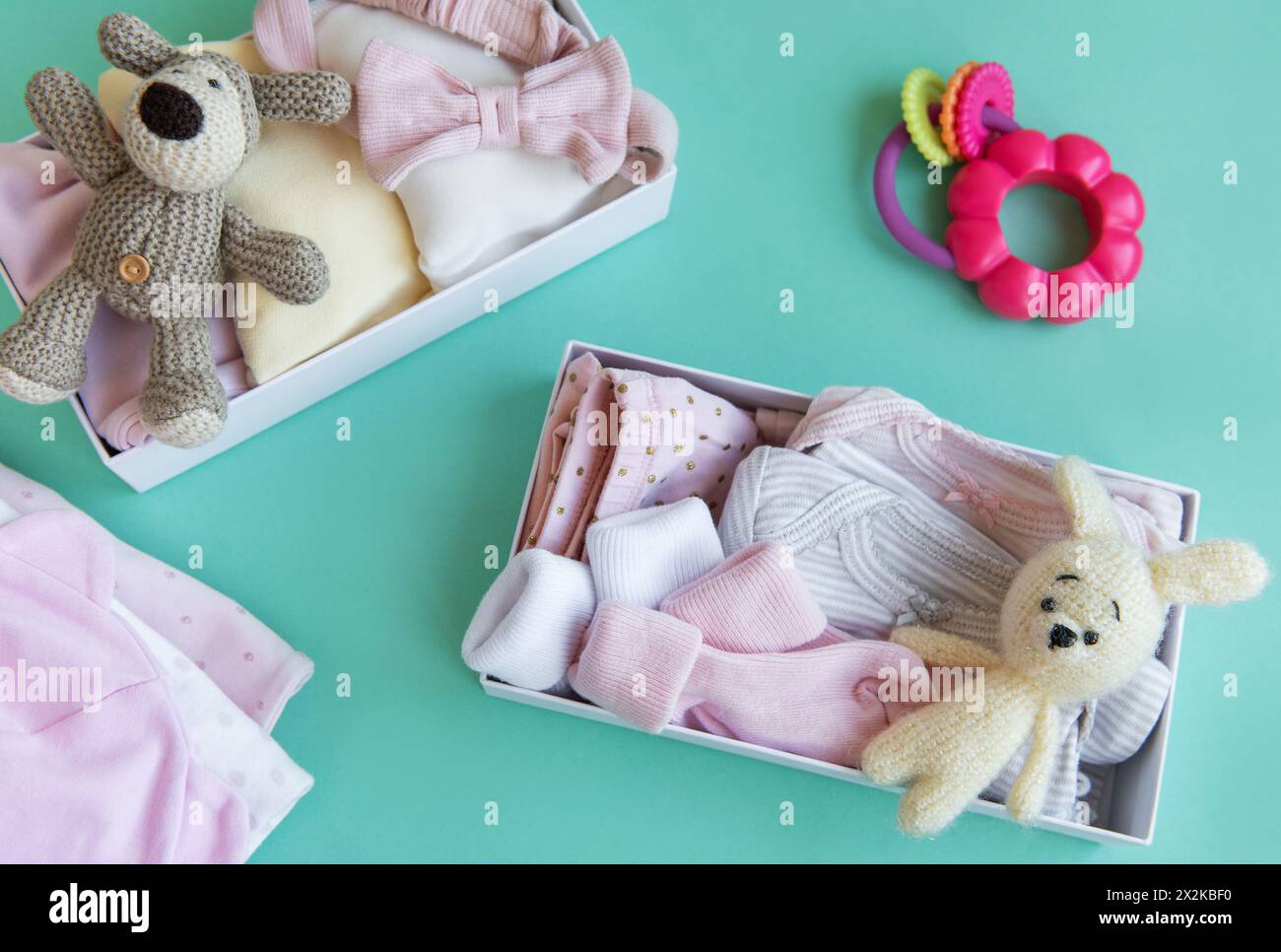 Baby and child clothes and knitted toys in carton box. Donation ...