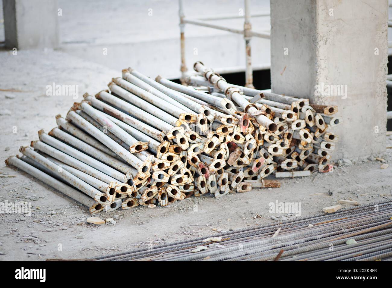 Scaffolding racks in disassembled form lie near a reinforced concrete ...
