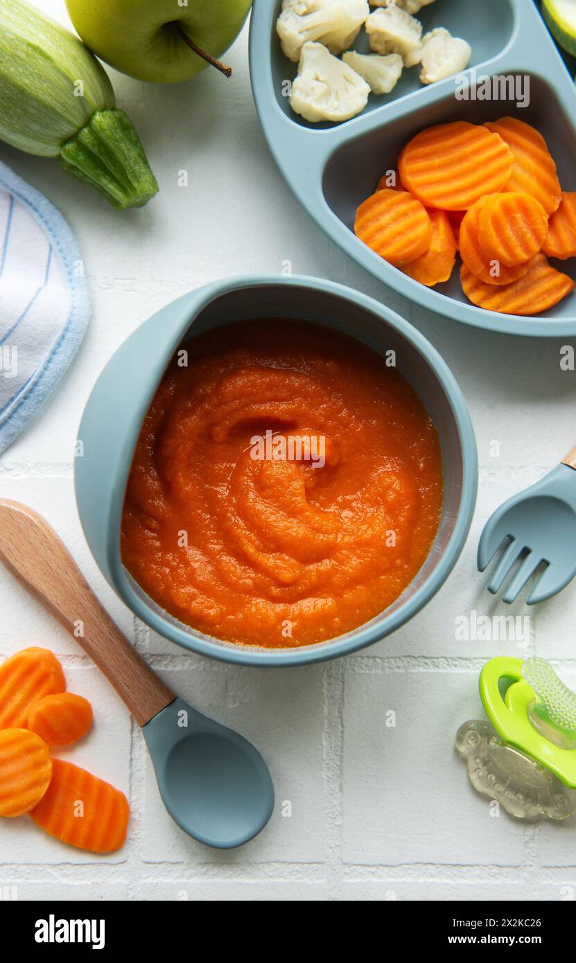 Healthy baby food in bowl. Baby food vegetable puree with carrot Stock ...