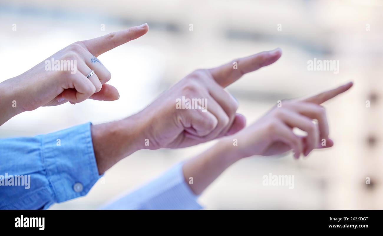 People, pointing and hands with direction to business in city with ...