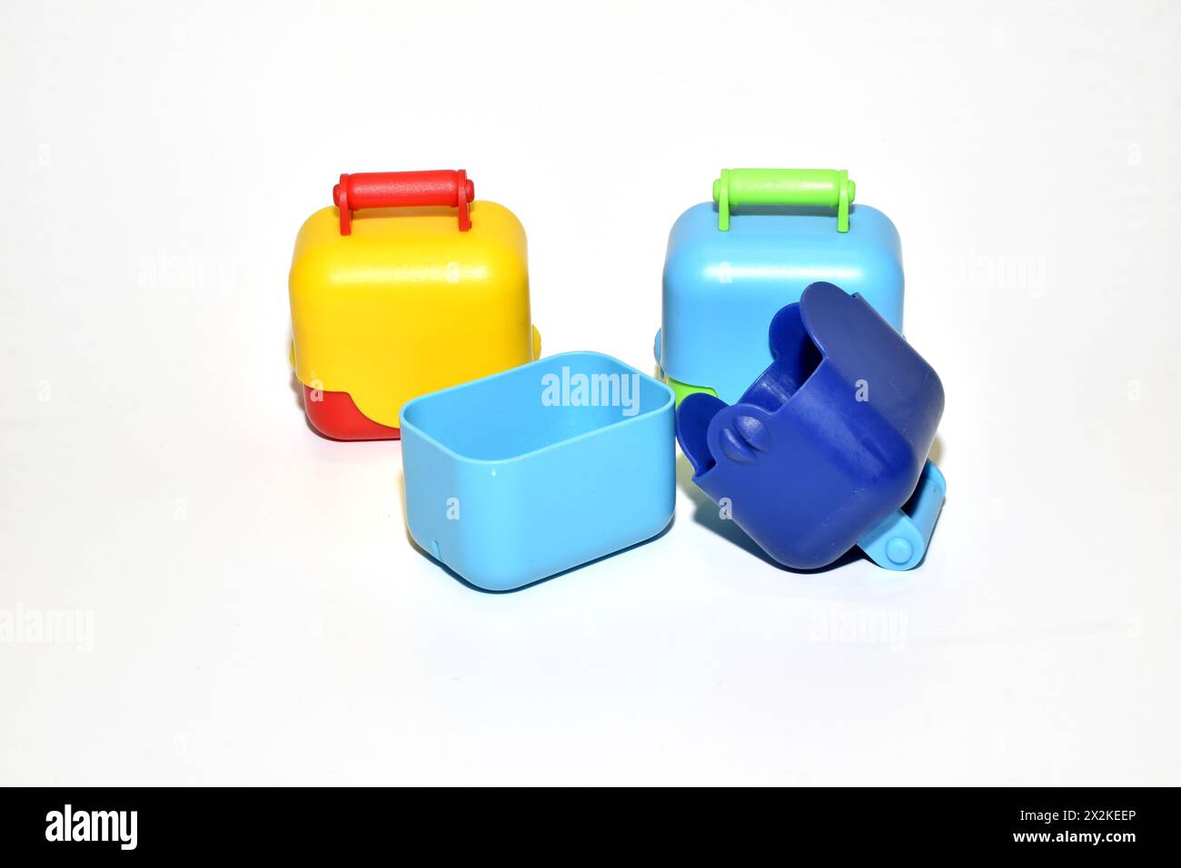 On a white background lie toy chests with handles, made of plastic ...