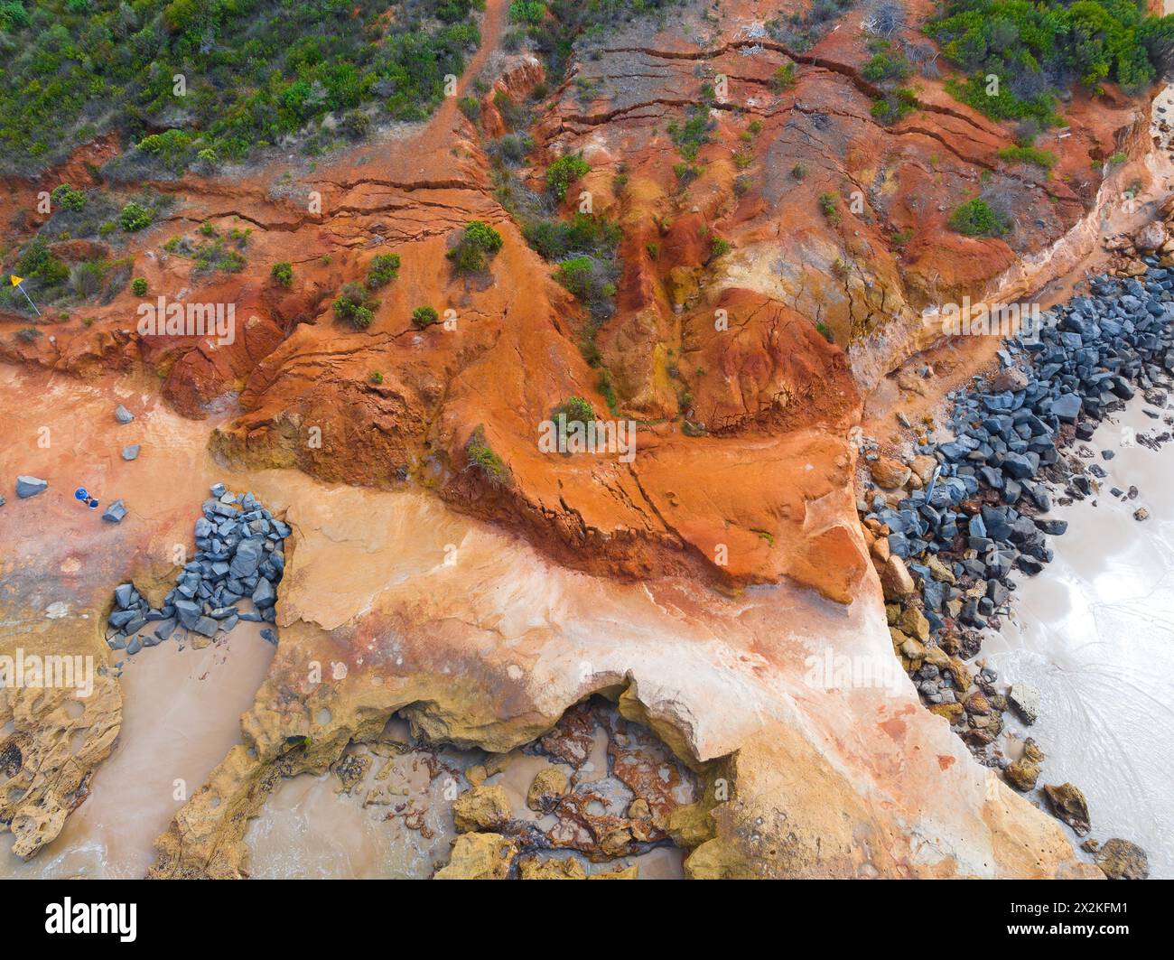 Aerial view of eroded coastal cliffs with large cracks at Point ...