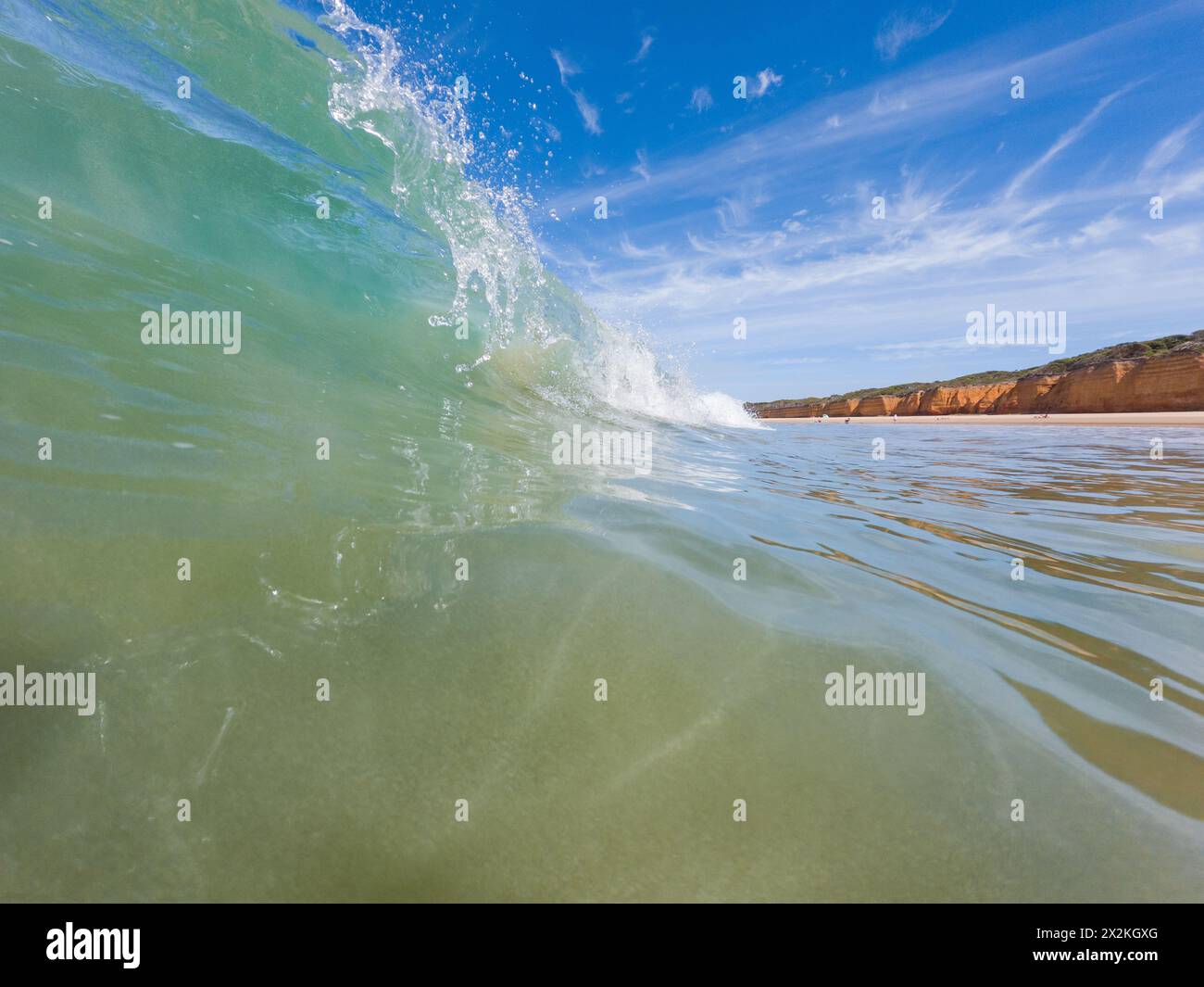 Low angled view of the crest of a wave crashing in shallow water at ...
