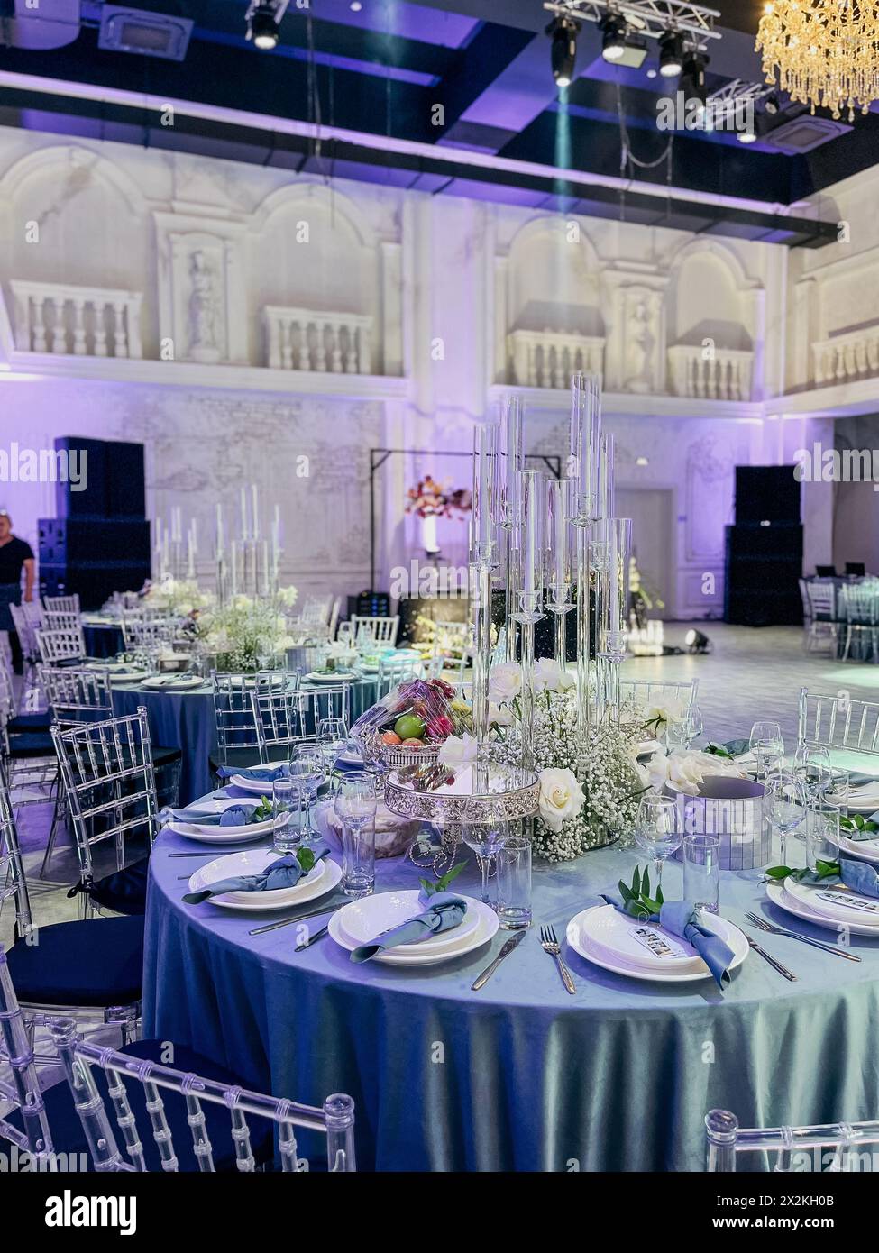 Elegant wedding reception hall with round tables and floral ...