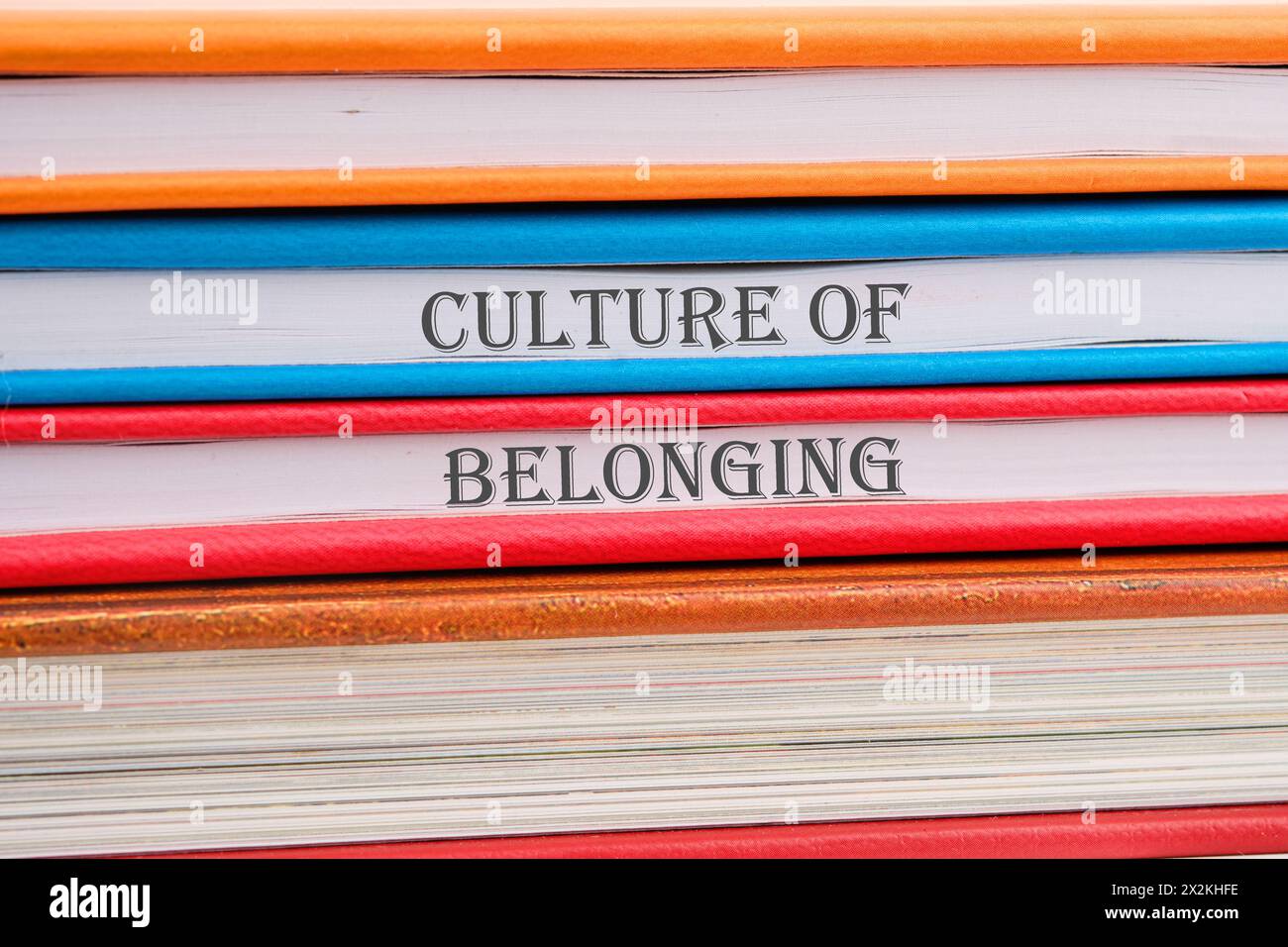 Culture of belonging symbol on notebooks stacked in a pile Stock Photo ...