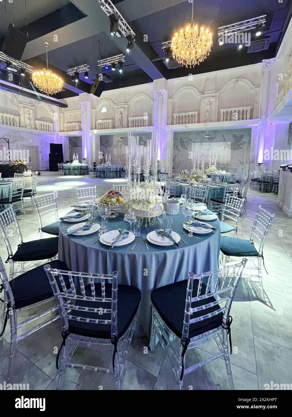 Elegant wedding reception hall with round tables and crystal ...
