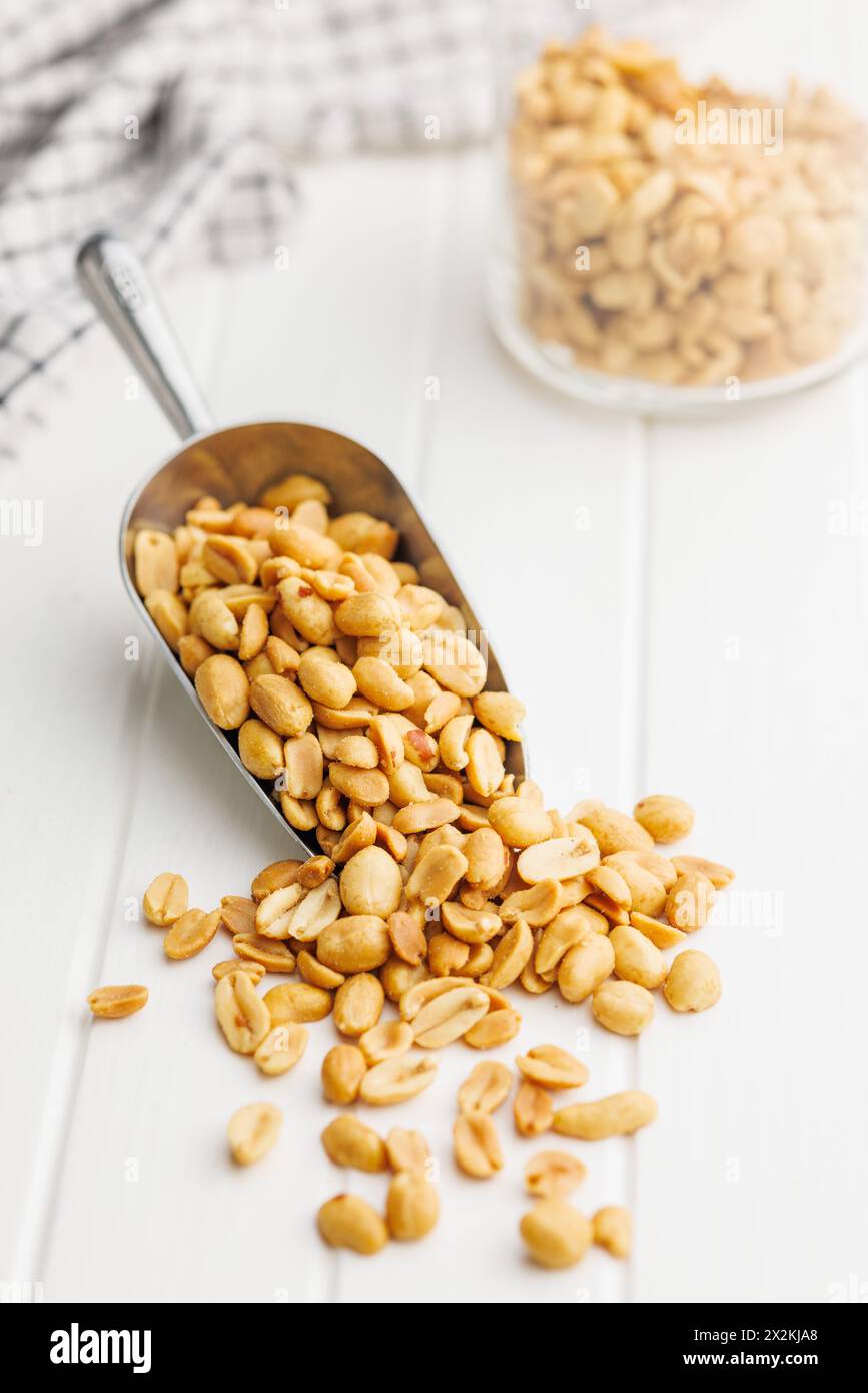 Salted roasted peanuts in scoop on a kitchen table Stock Photo - Alamy